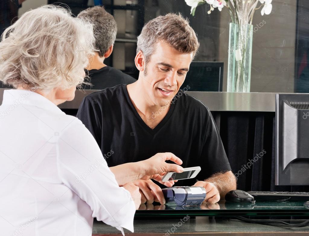 Customer Paying Through Mobile Phone At Salon Stock Photo by ...