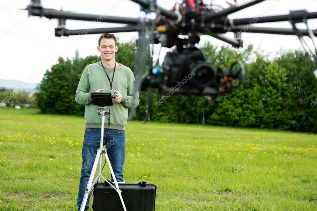Happy Engineer Operating UAV in Park — Stock Photo © SimpleFoto #31183015