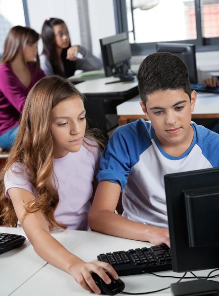 Schoolchildren Using Computer At Desk - Stock Image - Everypixel