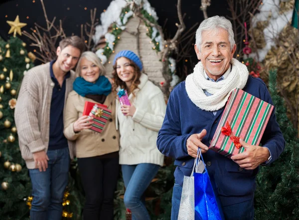 Happy Family With Christmas Presents And Shopping Bags At Store - Stock ...