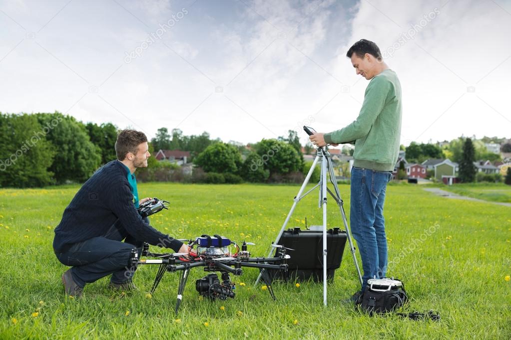 Engineers Working On UAV Helicopter in Park — Stock Photo © SimpleFoto ...