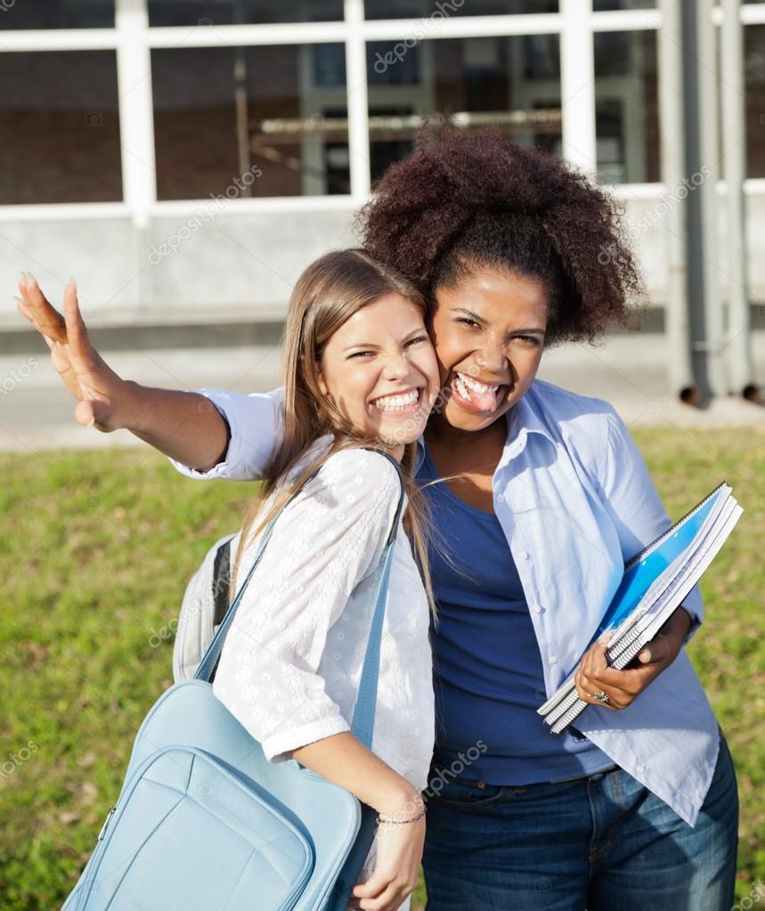 Female Students Making Facial Expressions On Campus Stock Photo by ...