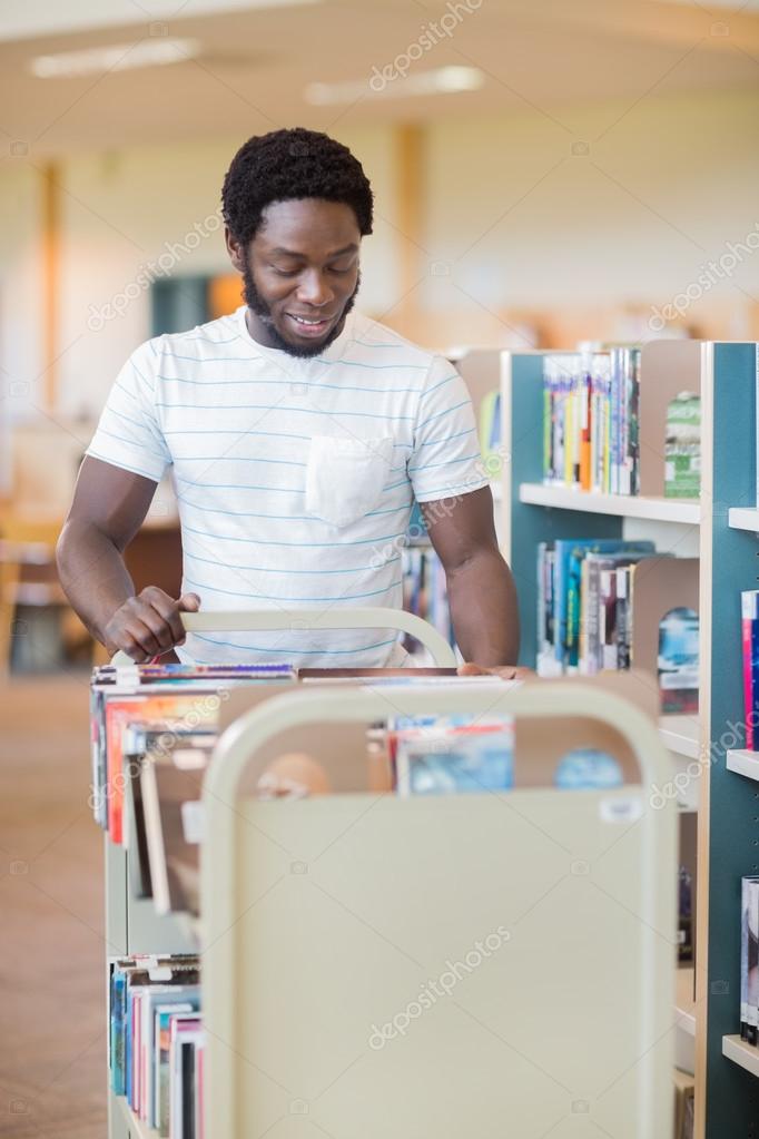 Librarian With Trolley Of Books In Library — Stock Photo © SimpleFoto ...