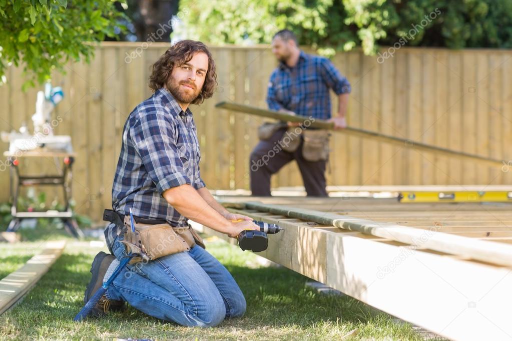 Worker Drilling Wood At Construction Site Stock Photo by ©SimpleFoto ...