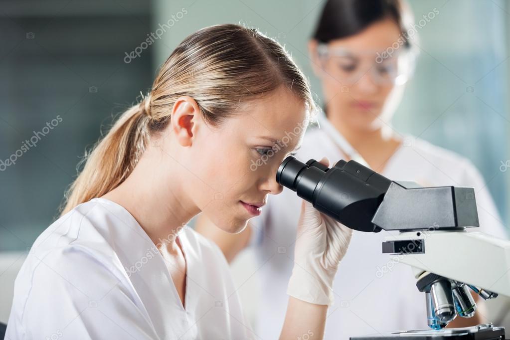 Female Technician Looking Into Microscope — Stock Photo © SimpleFoto ... Female Technician Looking Into Microscope — Stock Photo © SimpleFoto ...