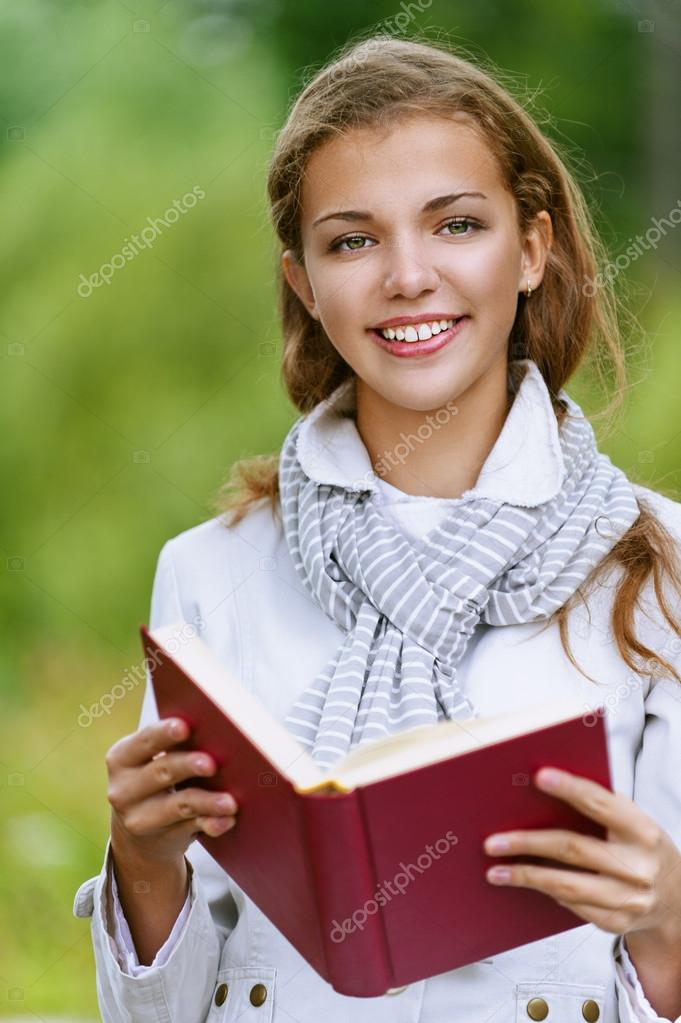 Beautiful woman reading red book Stock Photo by ©BestPhotoStudio 13638558