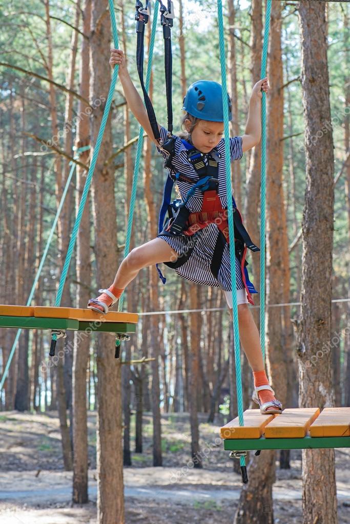 Little girl climbs on rope harness — Stock Photo © BestPhotoStudio ...