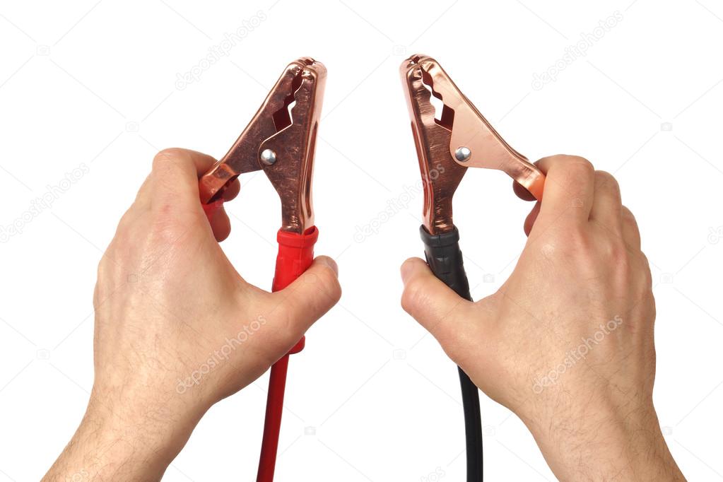 Hands with jumper cables on white Stock Photo by ©phodopus 47000565