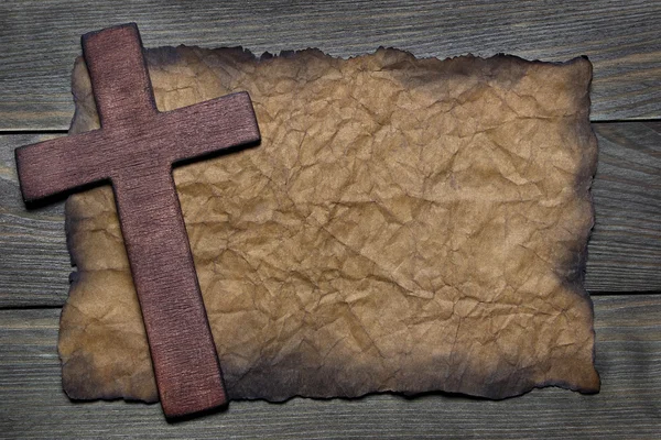 Wooden cross on old paper Stock Photo by ©papkin 30353413