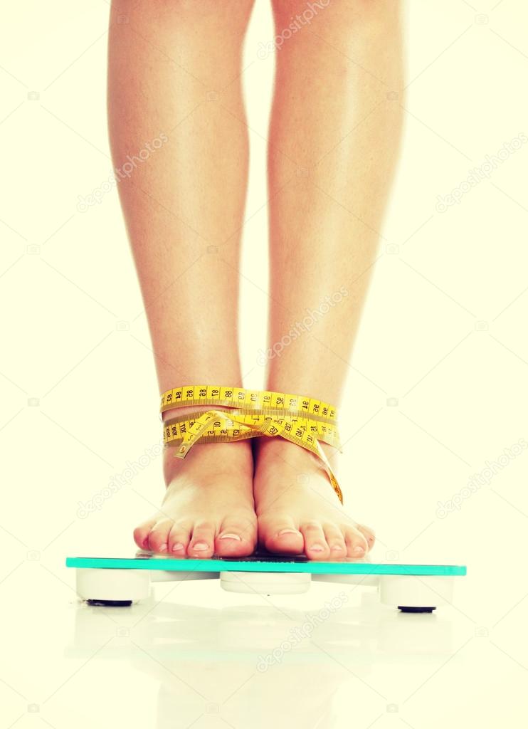 Female legs on scale Stock Photo by ©piotr_marcinski 41012929