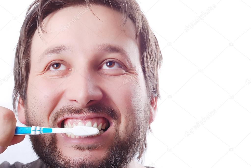 Man cleaning teeth with brush Stock Photo by ©zurijeta 21444007
