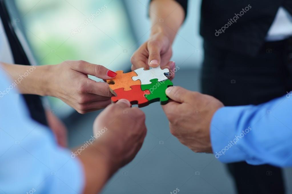 Group of business people assembling jigsaw puzzle Stock Photo by ...