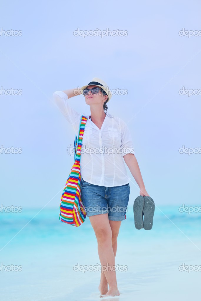 Beautiful girl walking at beach Stock Photo by ©.shock 34888313