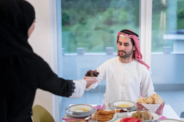 modern multiethnic Muslim family sharing a bowl of dates while enjoying ...