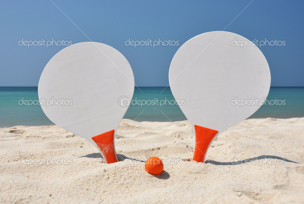 Two racket and a ball on the sandy beach Stock Photo by ©happyalex 21012465
