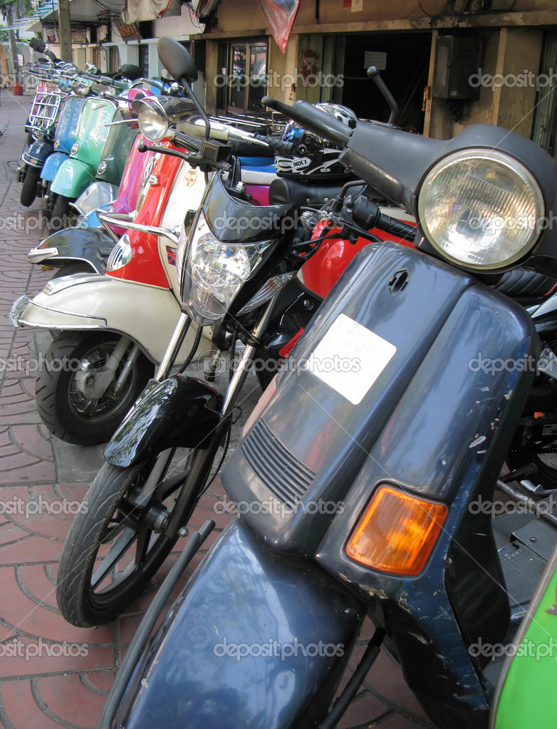 Row of mopeds on a street of Bangkok — Stock Photo © happyalex #21064243