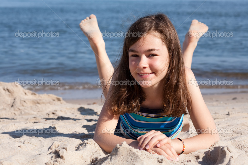 Girl lying on beach Stock Photo by ©gbh007 32839999