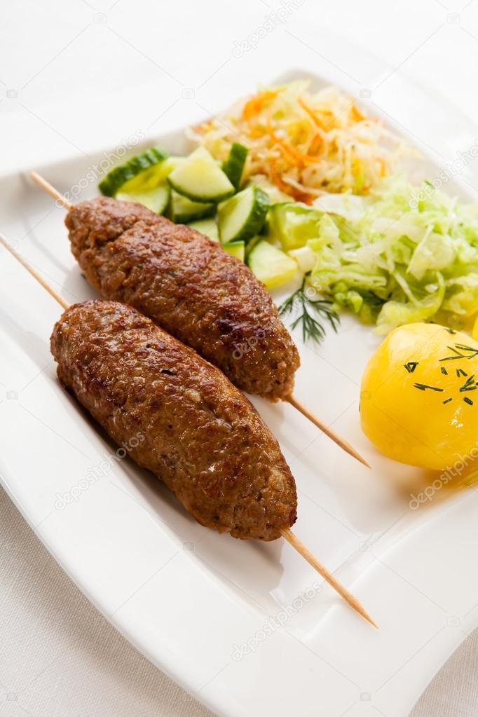 Roasted kebab with potatoes and vegetables Stock Photo by ©gbh007 32950325