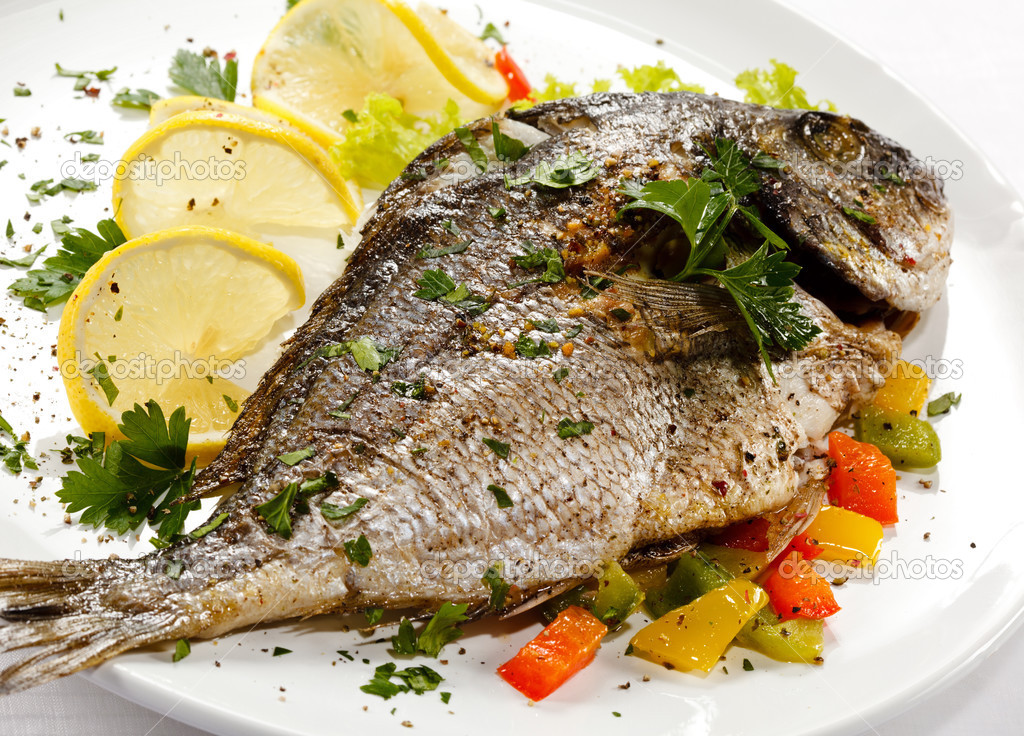 Fish dish - roasted fish and vegetables — Stock Photo © gbh007 #33471443