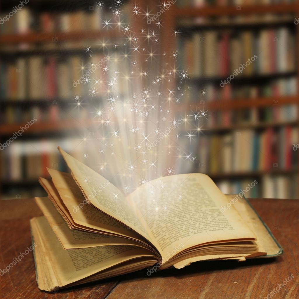 Opened magic book with magic light Stock Photo by ©alga38 38296587