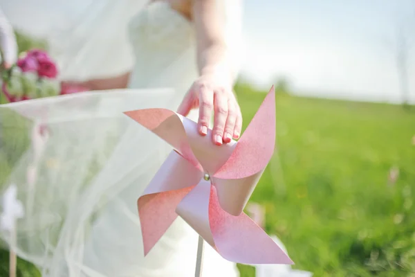 Paper windmill in green grass field - Stock Image - Everypixel