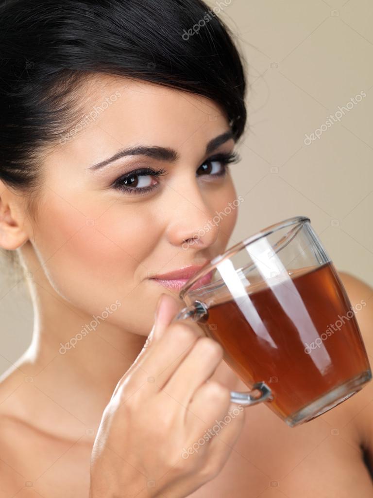 Attractive woman drinking tea Stock Photo by ©dashek 19182721