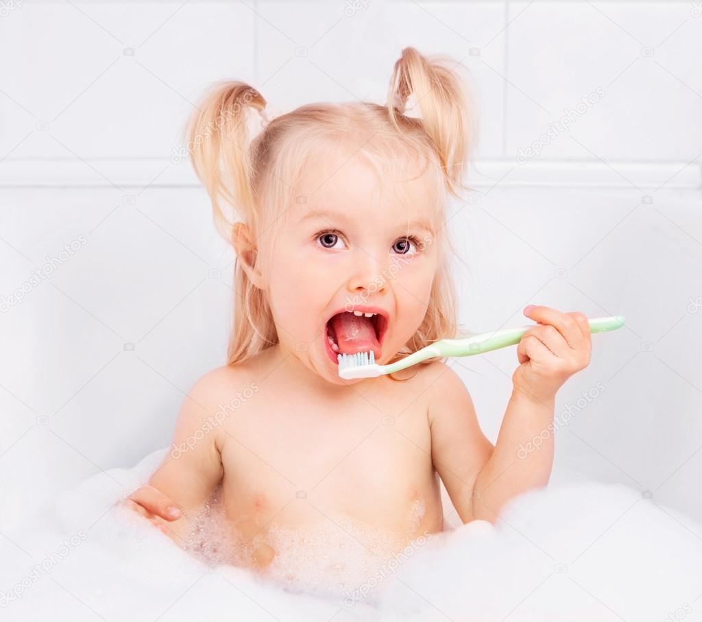 Baby brushing teeth — Stock Photo © Photolin #25327673