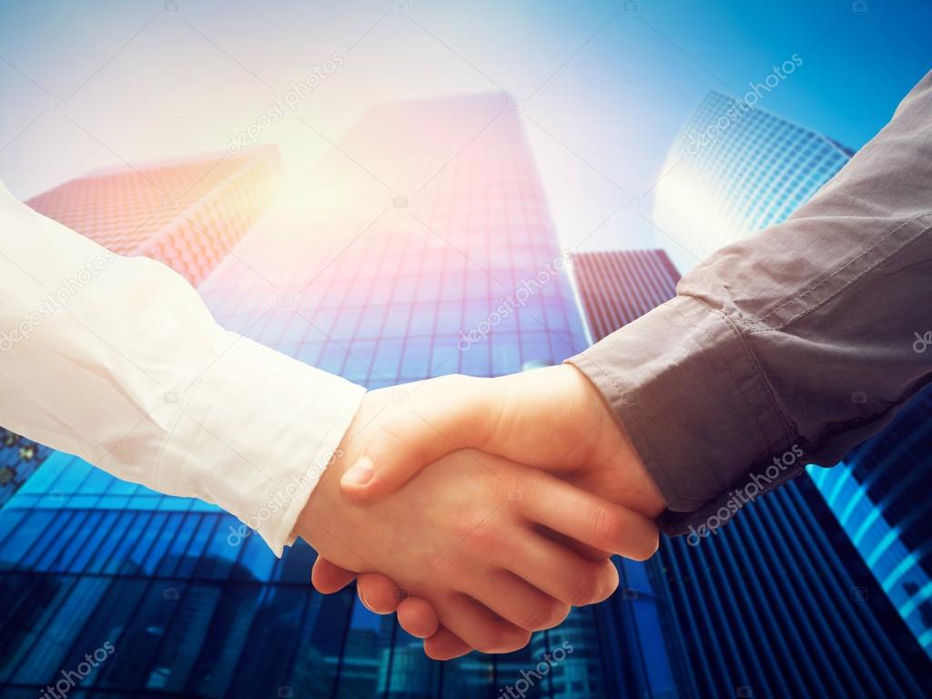 Business handshake, skyscrapers background Stock Photo by ©Photocreo ...