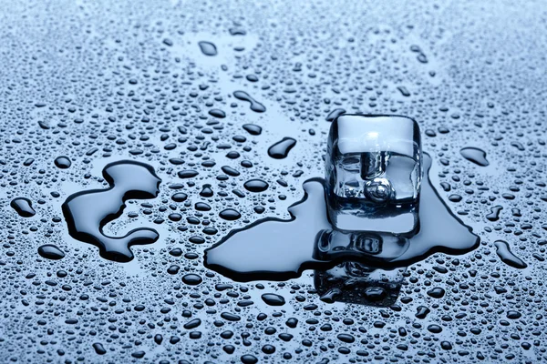 Ice cube over dark background - Stock Image - Everypixel