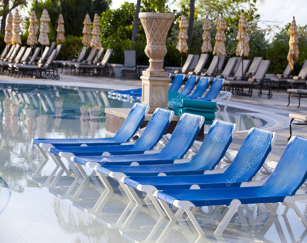 Empty beach chair before pool Stock Photo by ©KKulikov 51243477