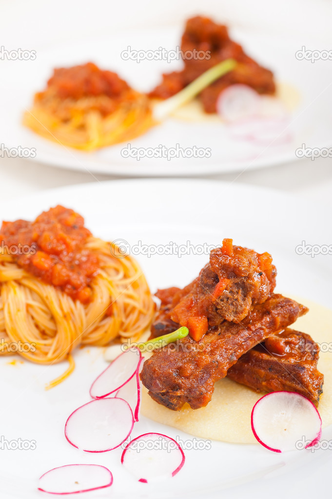 Pasta with pork ribs sauce on polenta bed Stock Photo by ©keko64 24172645