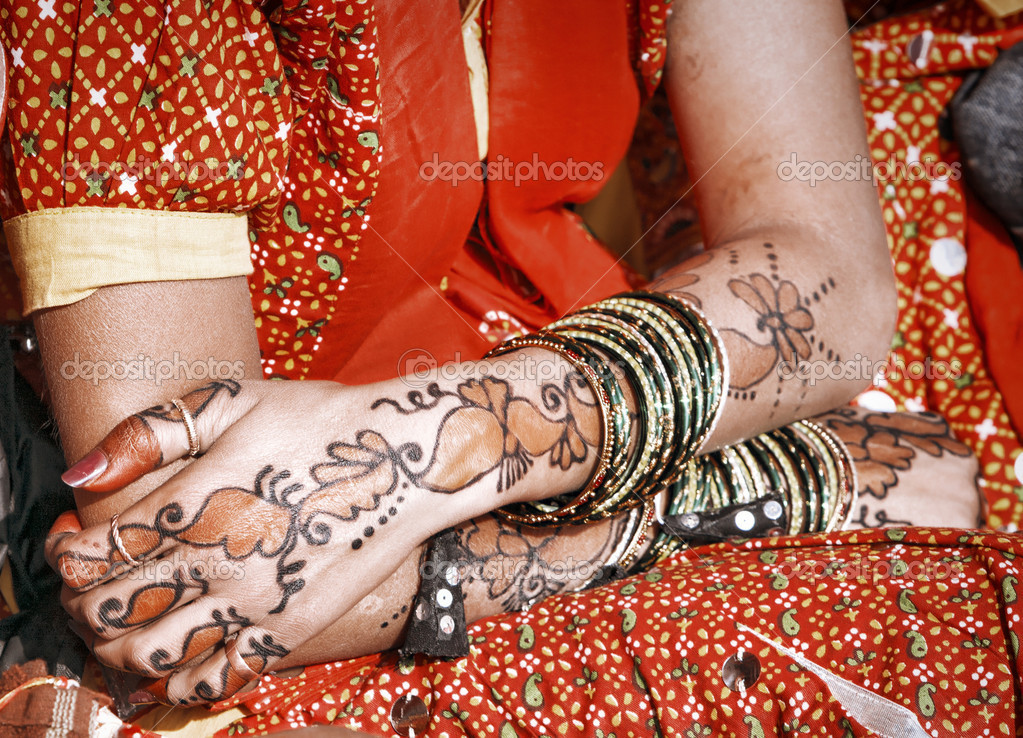 Hands of a young Indian woman adorned with traditional bangles and ...