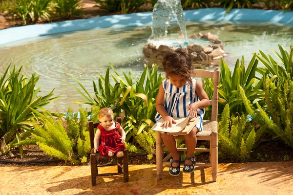 Reading to her doll - Stock Image - Everypixel