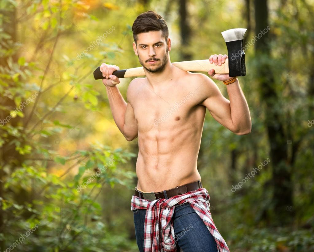 Sexy lumberjack in forest Stock Photo by ©luckybusiness 39627509