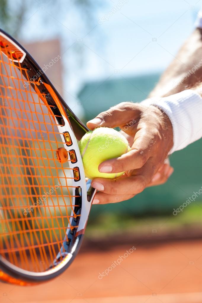 Hand with tennis ball and racket Stock Photo by ©luckybusiness 39654173