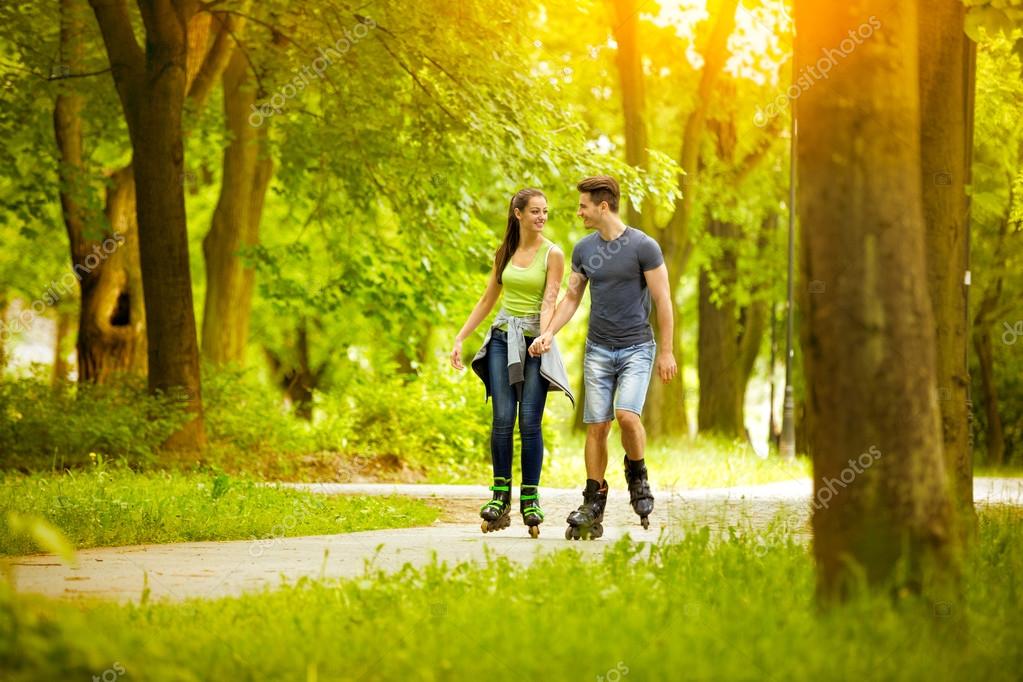 Couple wearing in line skates in park — Stock Photo © luckybusiness ...