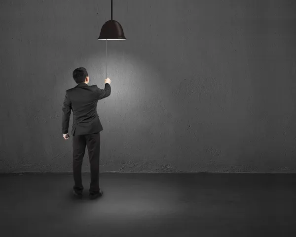 Businessman turn on the light - Stock Image - Everypixel