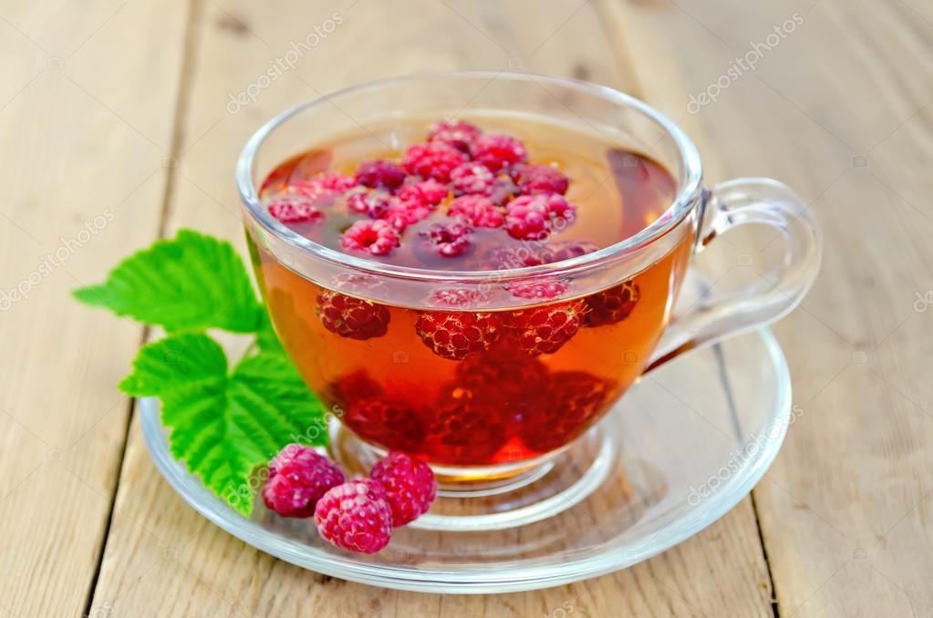 Tea with raspberry and leaf in a cup on board — Stock Photo © rezkrr ...