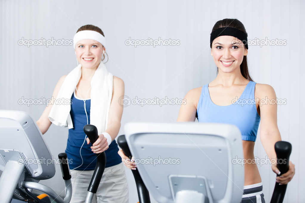 Two women training on training apparatus in gym — Stock Photo ...