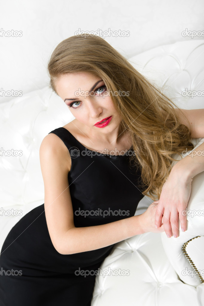 Female sitting on white leather sofa Stock Photo by ©agencyby 33826325