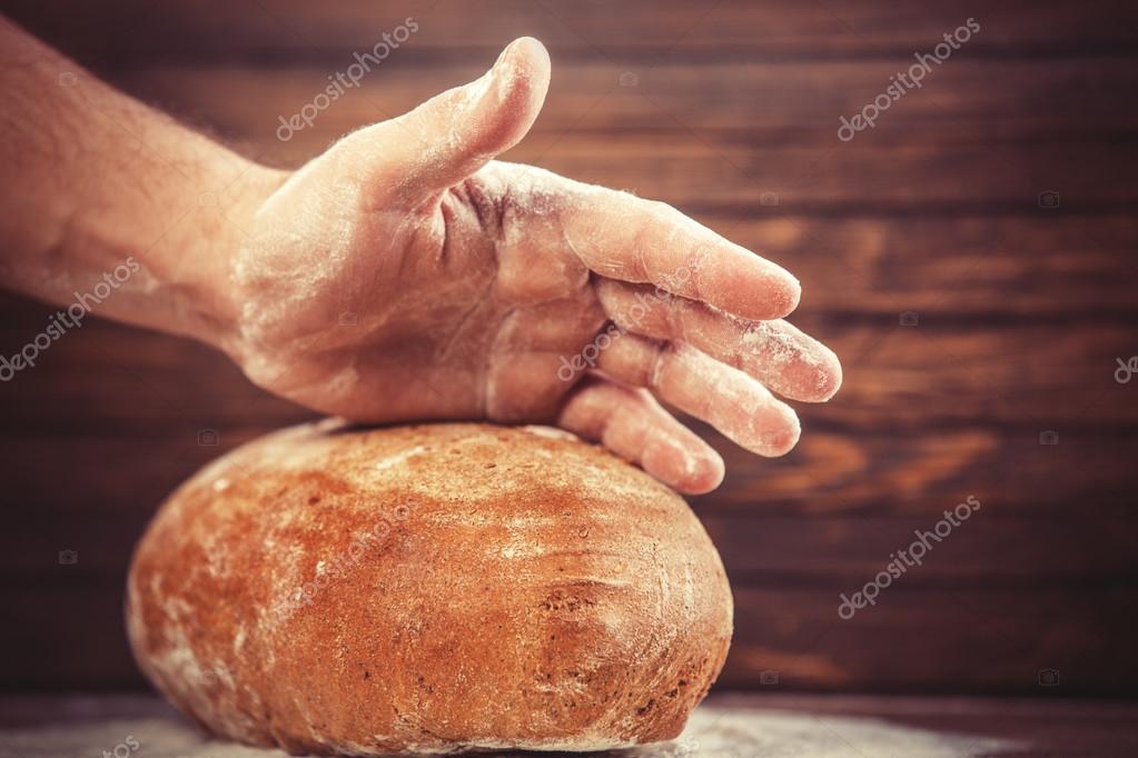 Baker's hands with a bread. — Stock Photo © massonforstock #39266443