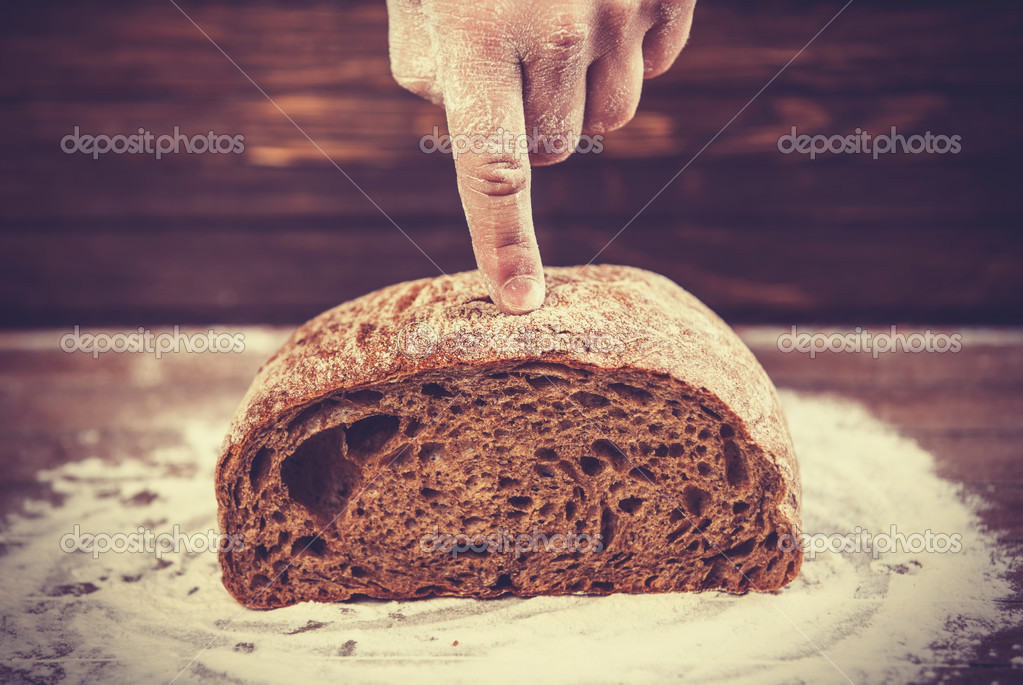 Baker's hands with a bread. — Stock Photo © massonforstock #39266447