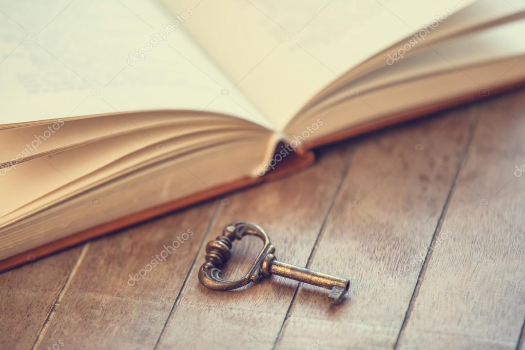 Retro key and opened book on wooden table. Stock Photo by ...