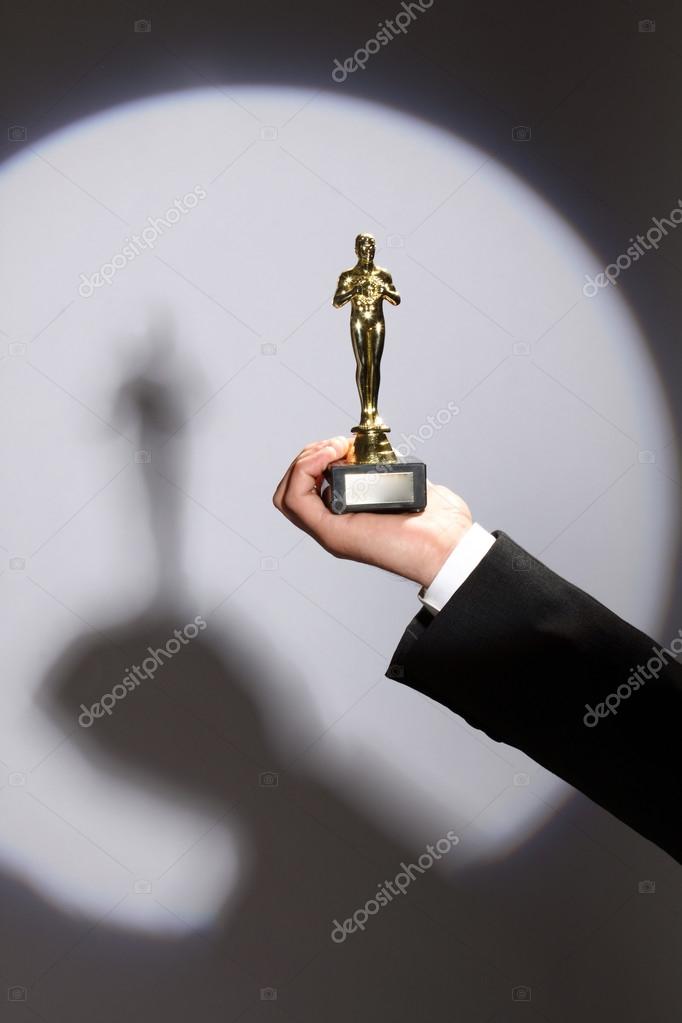 Oscar award in hand — Stock Editorial Photo © AlexKosev #22508259