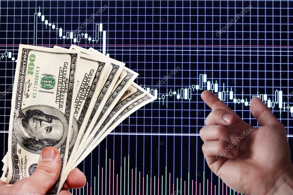 Dollar notes in a hand and instructions other hand on the schedu ...