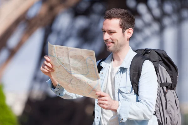 Young attractive tourist reading map in Paris - Stock Image - Everypixel