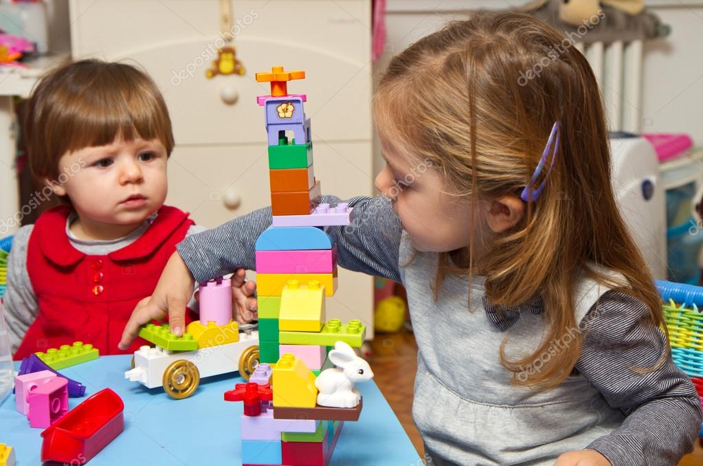 Little girls playing with building bricks Stock Photo by ©lsantilli ...