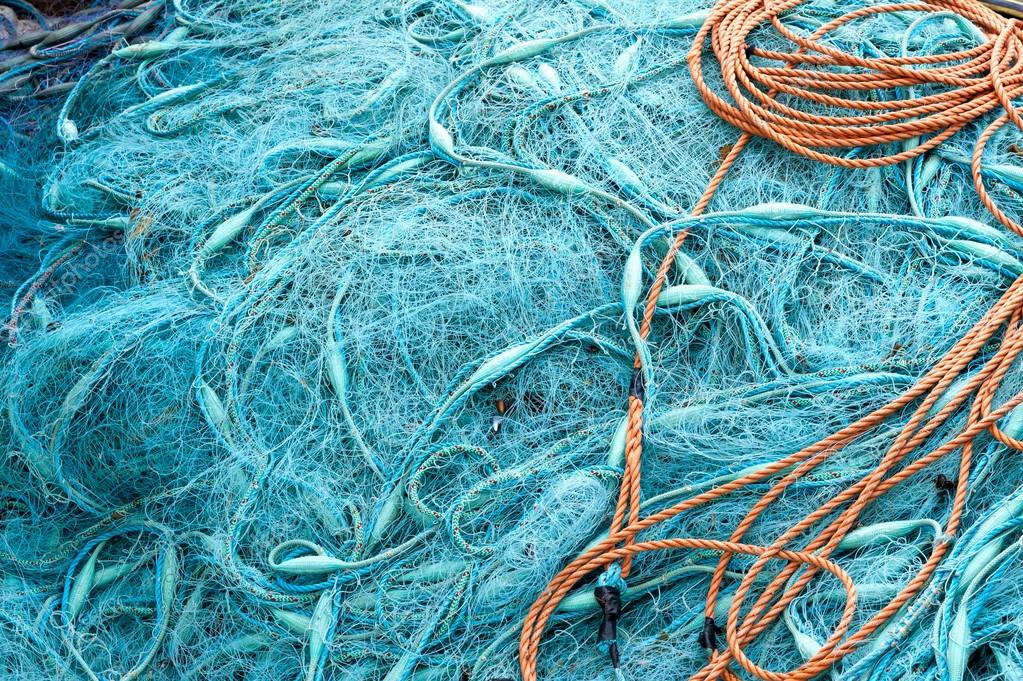 Pile of blue fishing nets Pile of blue fishing nets Stock Photo by ...