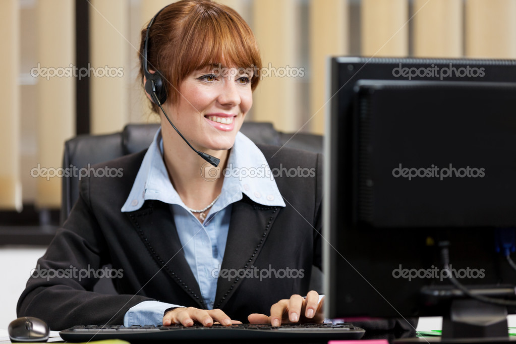 Female support assistant working at the helpdesk — Stock Photo ...