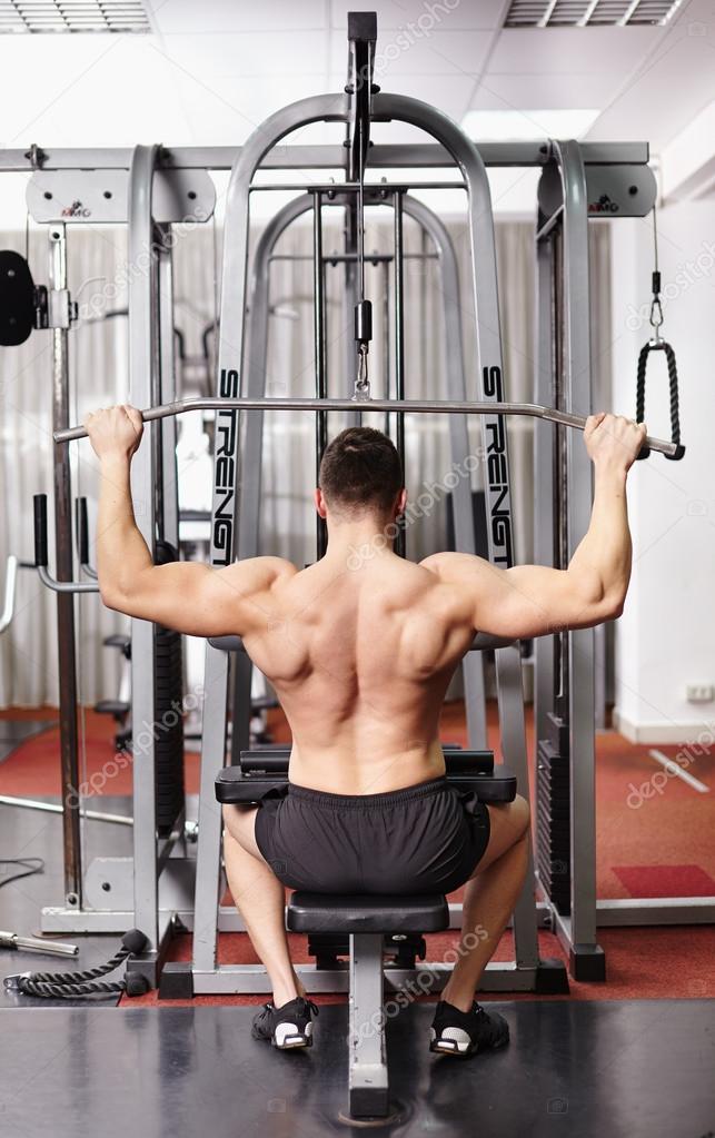 Athletic man pulling heavy weights Stock Photo by ©Xalanx 37799759